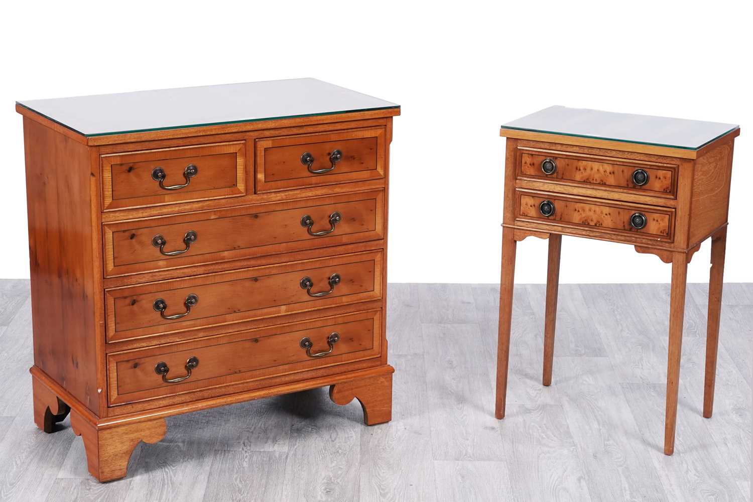 Lot 55 - A Georgian style yew wood chest of drawers;
